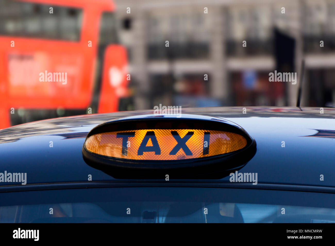 Cloce up of an illuminated taxi sign Stock Photo - Alamy