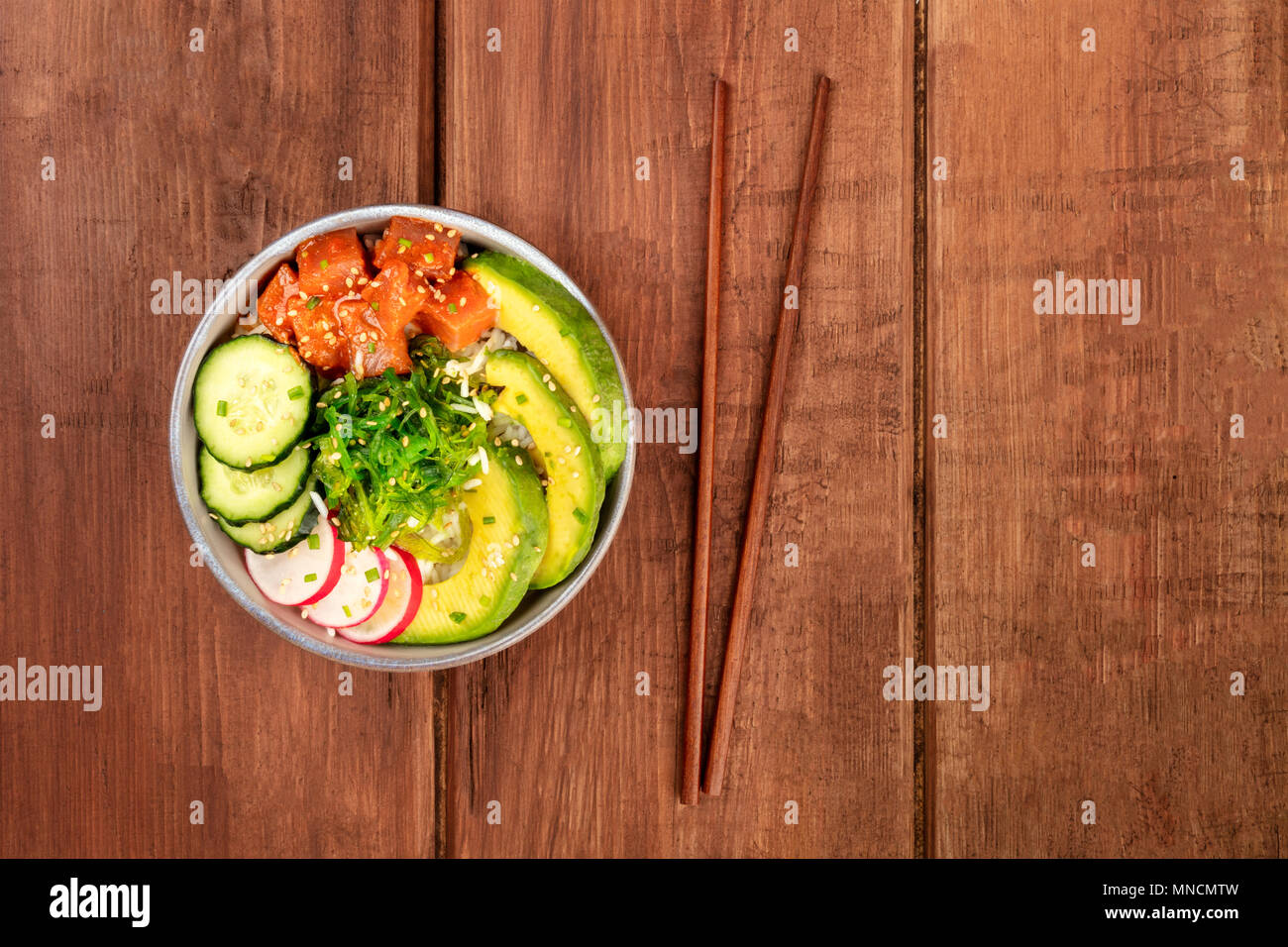 An overhead photo of poke, traditional Hawaiian raw fish salad, with a ...