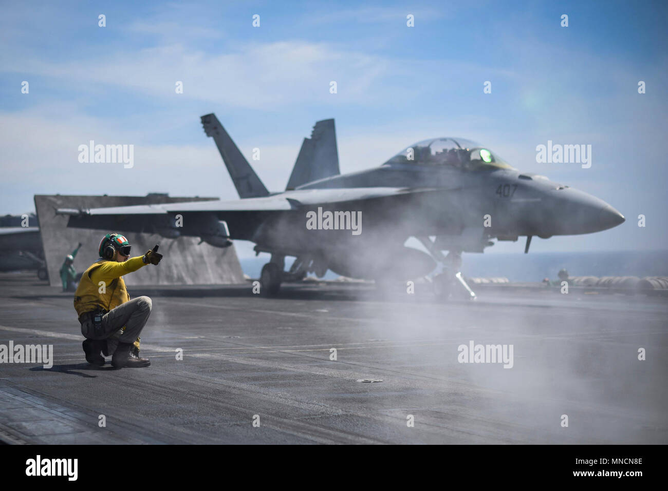 ARABIAN GULF (March 19, 2018) Lt. Alex Buscher signals to launch an F/A ...