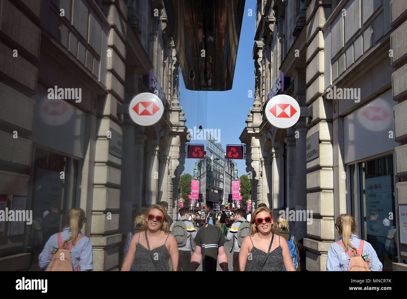 People walk past the bank branches of the HSBC and NatWest banks on ...