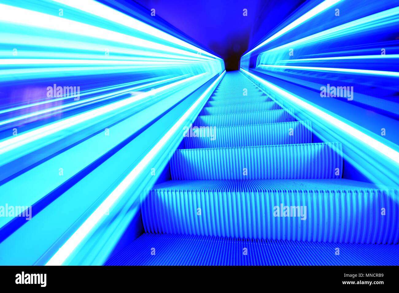 blue escalator stairway up wallpaper background Stock Photo - Alamy
