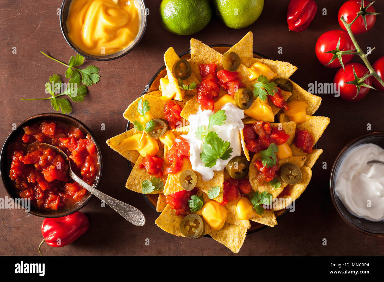 nachos loaded with salsa, cheese and jalapeno Stock Photo - Alamy