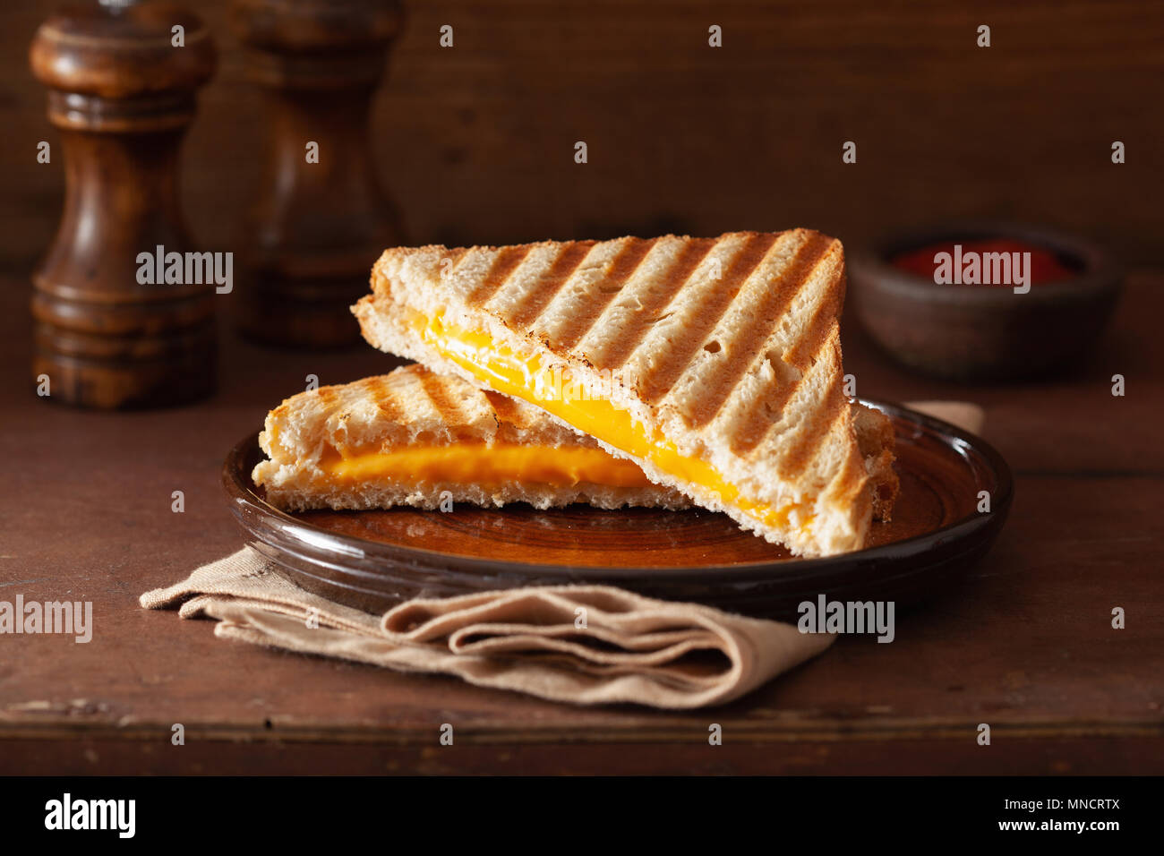 grilled cheese sandwich on rustic brown background Stock Photo - Alamy