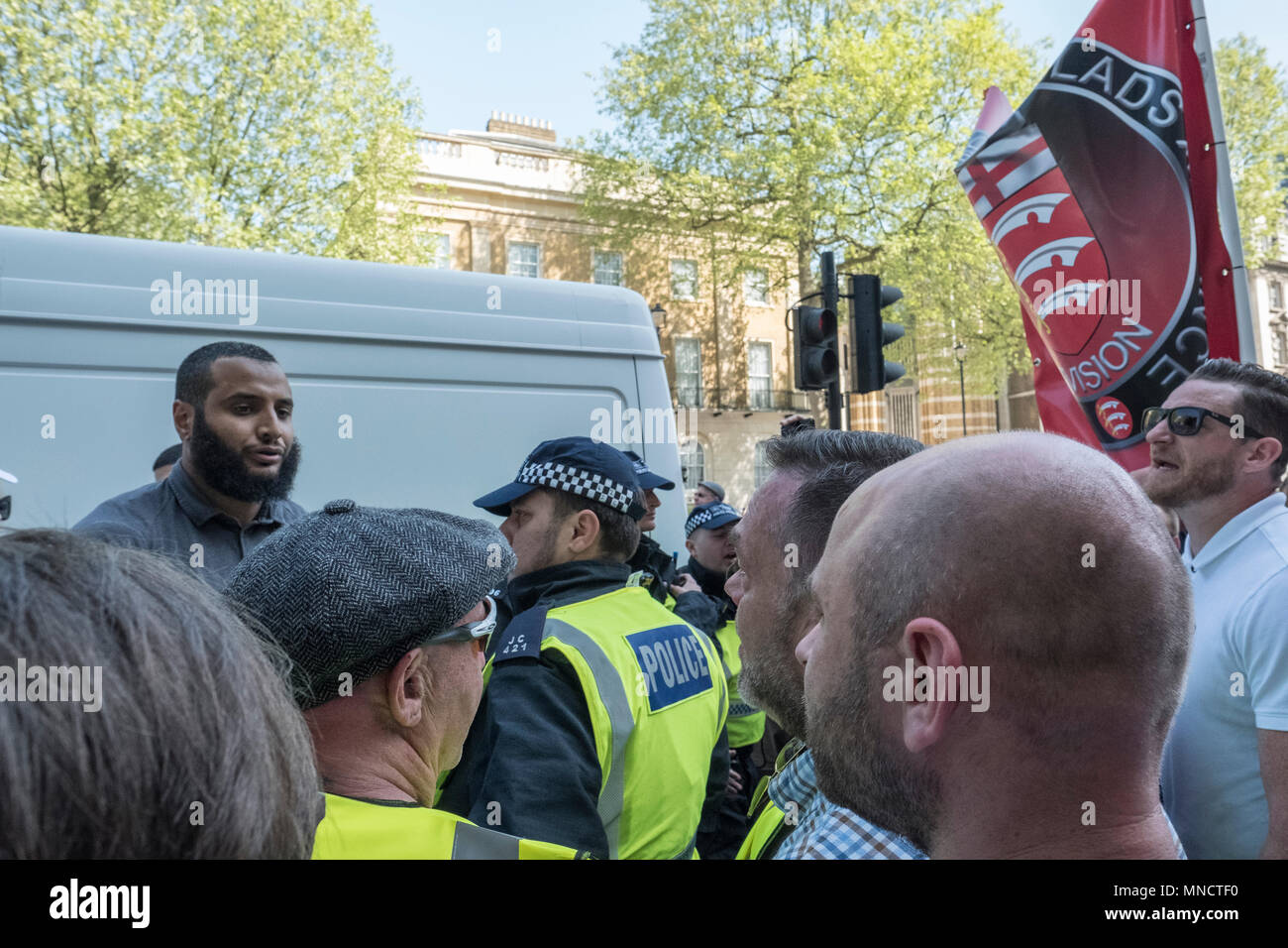 Mohammed Hijab is removed by police for his own protection during the ...