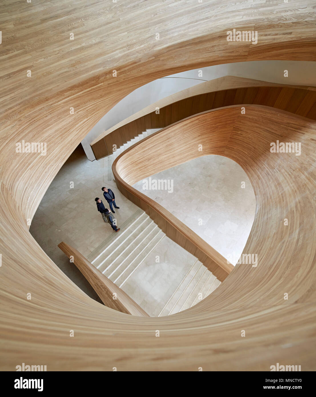 Timber clad curved stairway with figures from above. Harbin Opera House ...