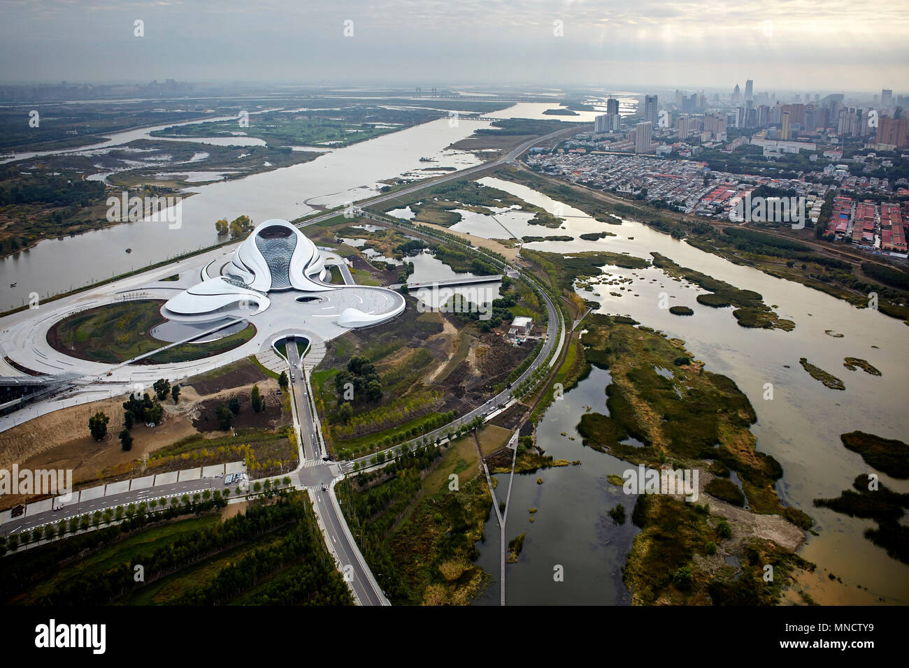 Aerial view of opera house embedded in Harbin's wetland with Songhua ...