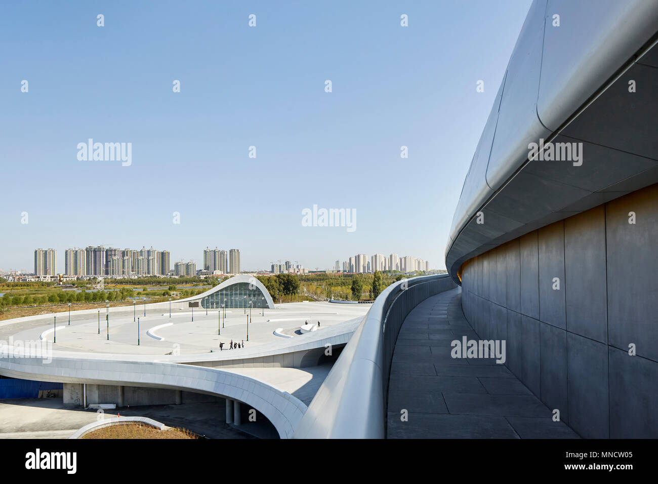 Elevated view from ramp, across piazza towards city skyline. Harbin ...