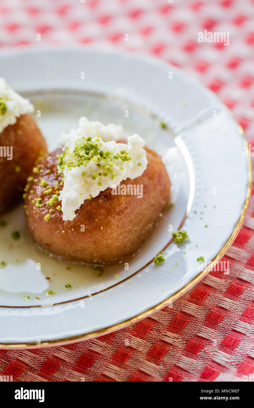 Turkish traditional dessert Kemalpasha, Shekerpare with cream on top ...