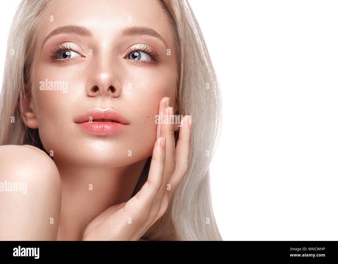 Beautiful young girl with a light natural make-up and perfect skin ...