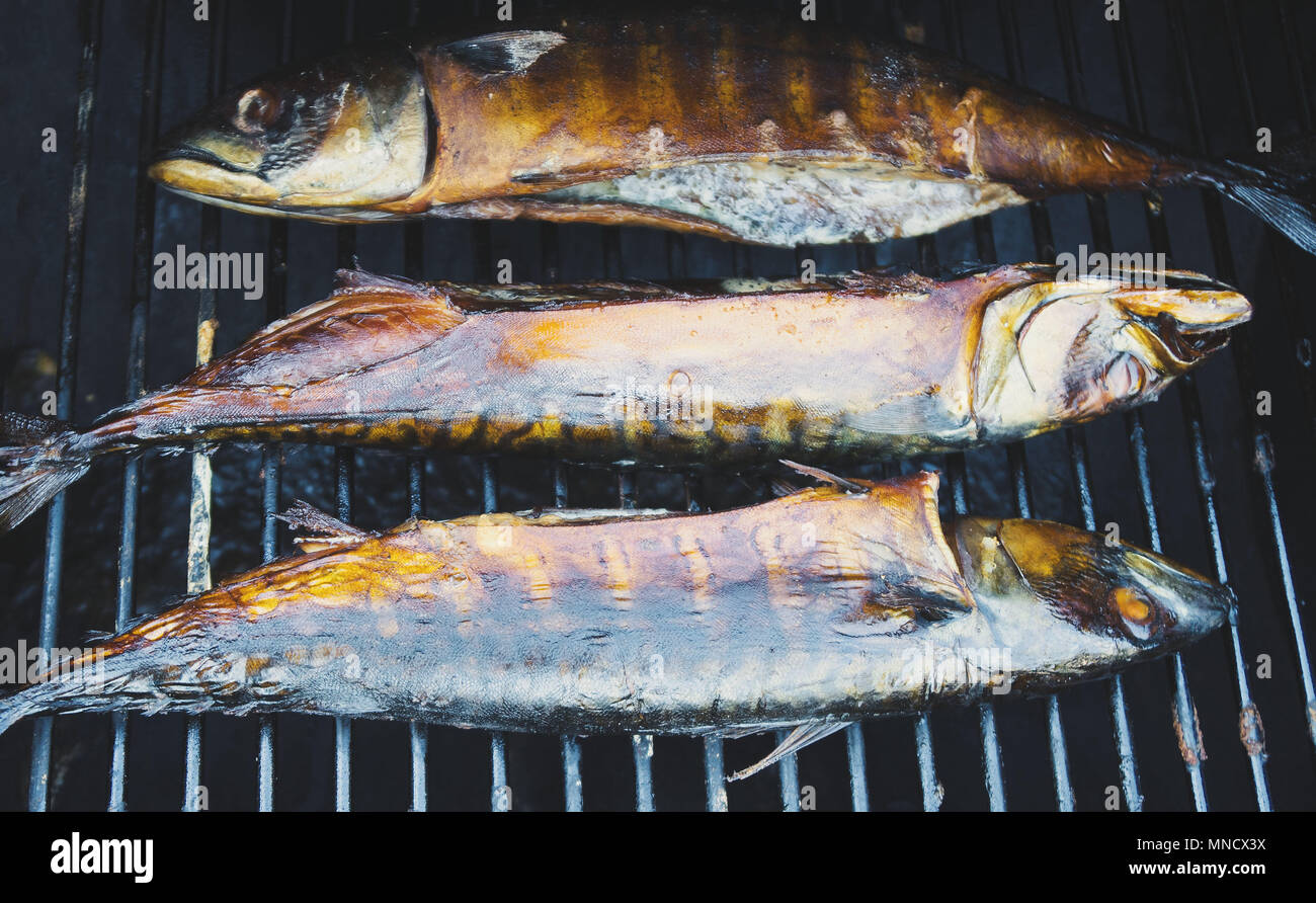 Smoked fish in smokehouse. Three sardines Stock Photo - Alamy
