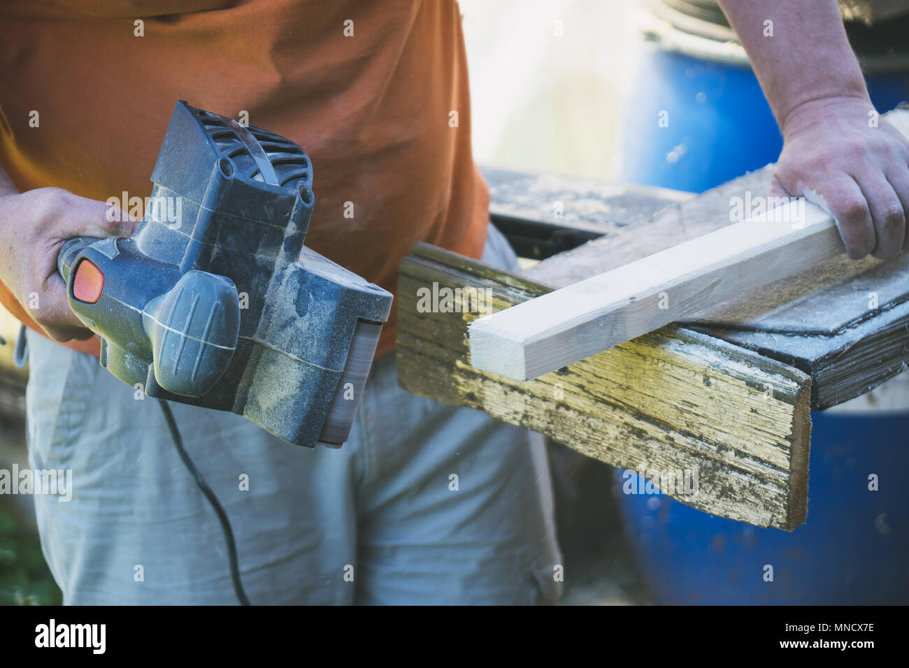 Handyman using electric sander machine outdoors Stock Photo - Alamy