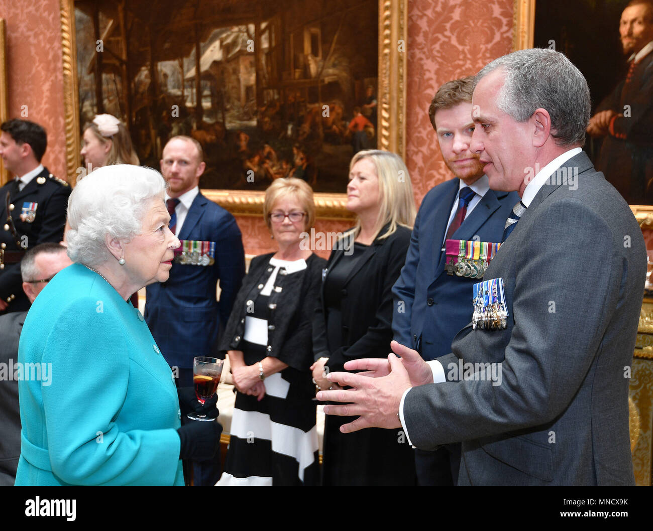 Queen Elizabeth II talks with Mr Dominic Troulan GC at a reception for ...