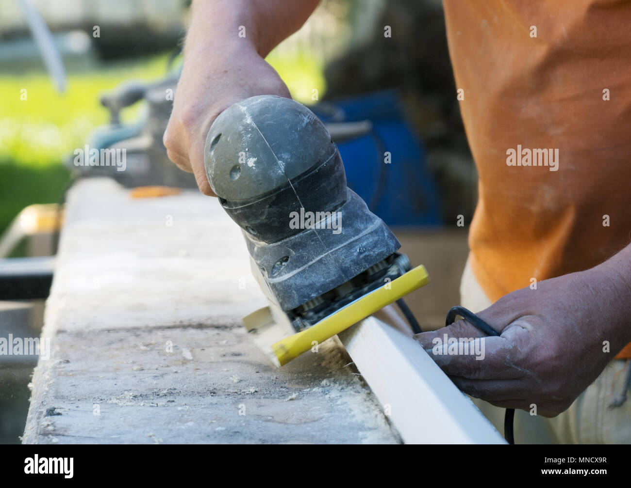 Handyman using electric sander machine outdoors Stock Photo - Alamy