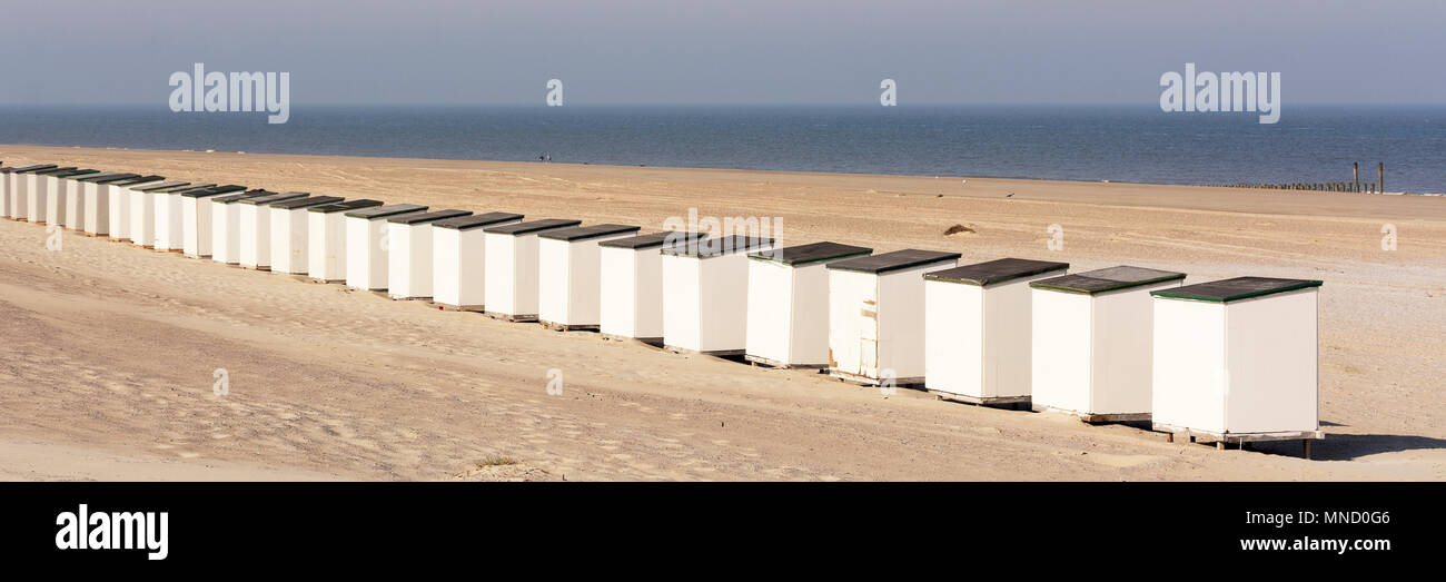 Typical Dutch sea landscape with a row of beach huts in line, with sand ...