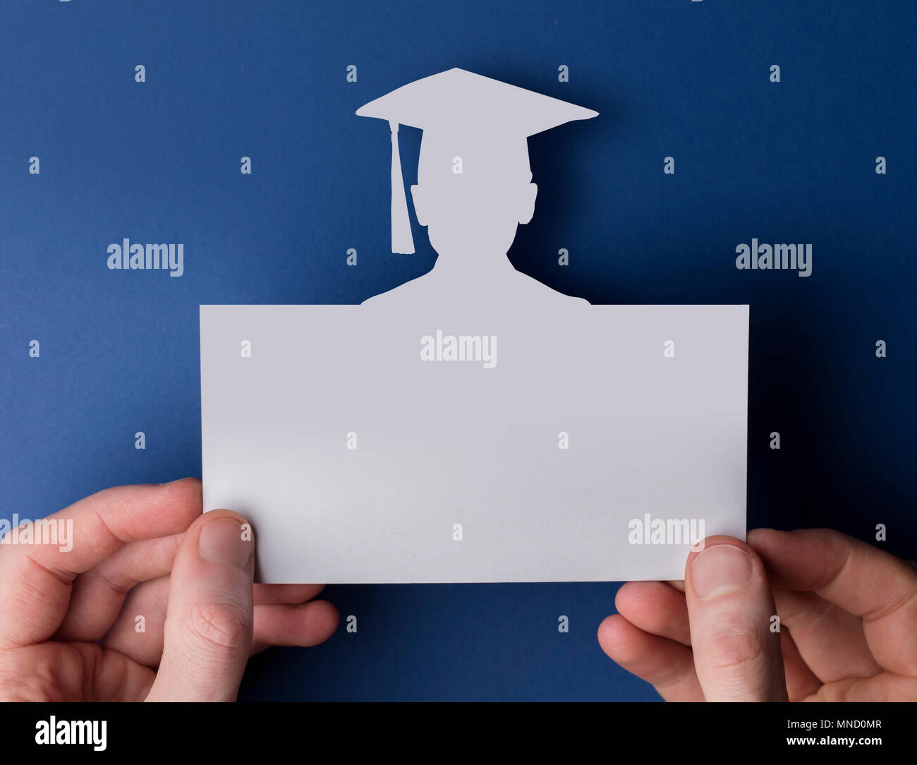 Graduation card. Male hands holding blank card with graduate cutout ...