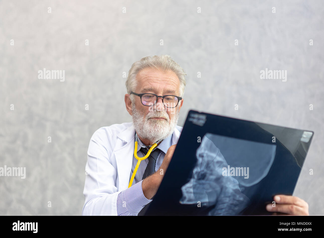 Senior medical doctor or chief doctor or Surgeon are checking skull of ...