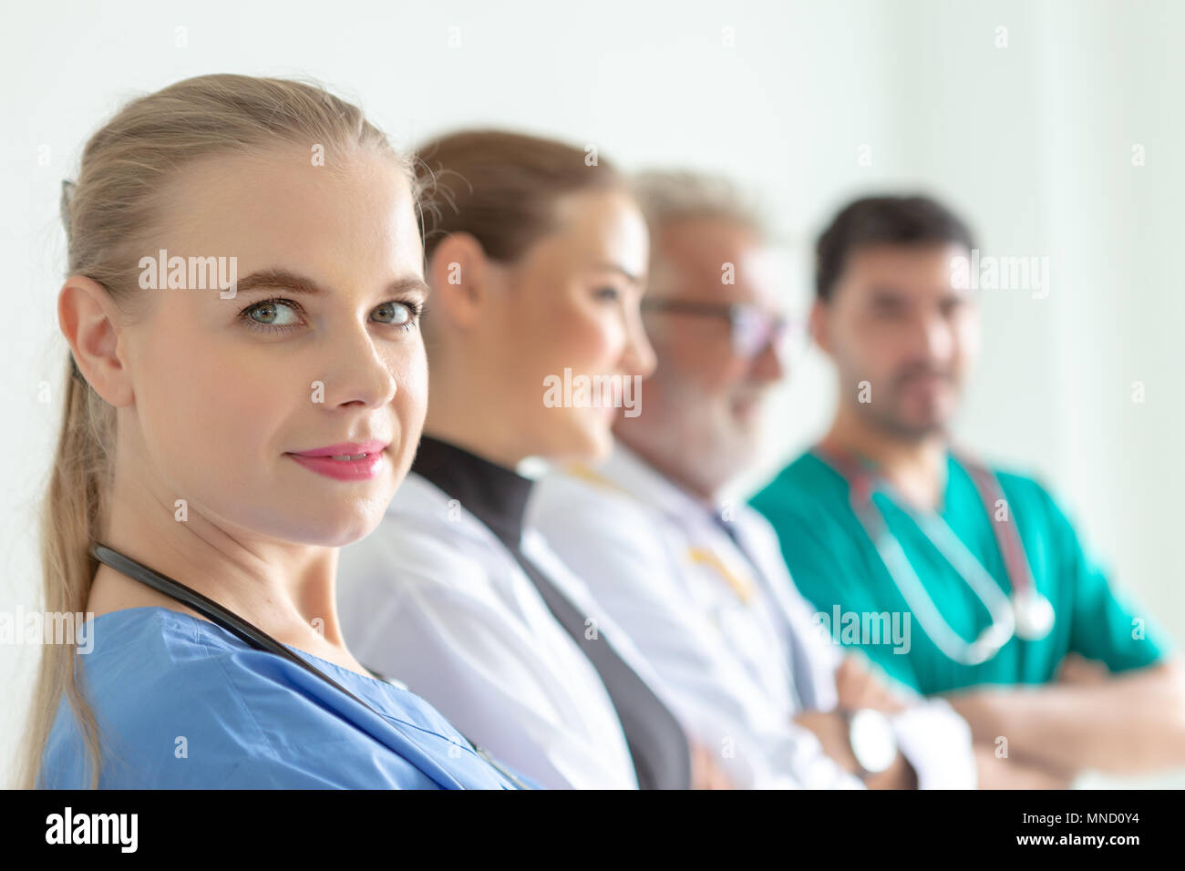 Confident female doctor looking at camera and smiling while her ...