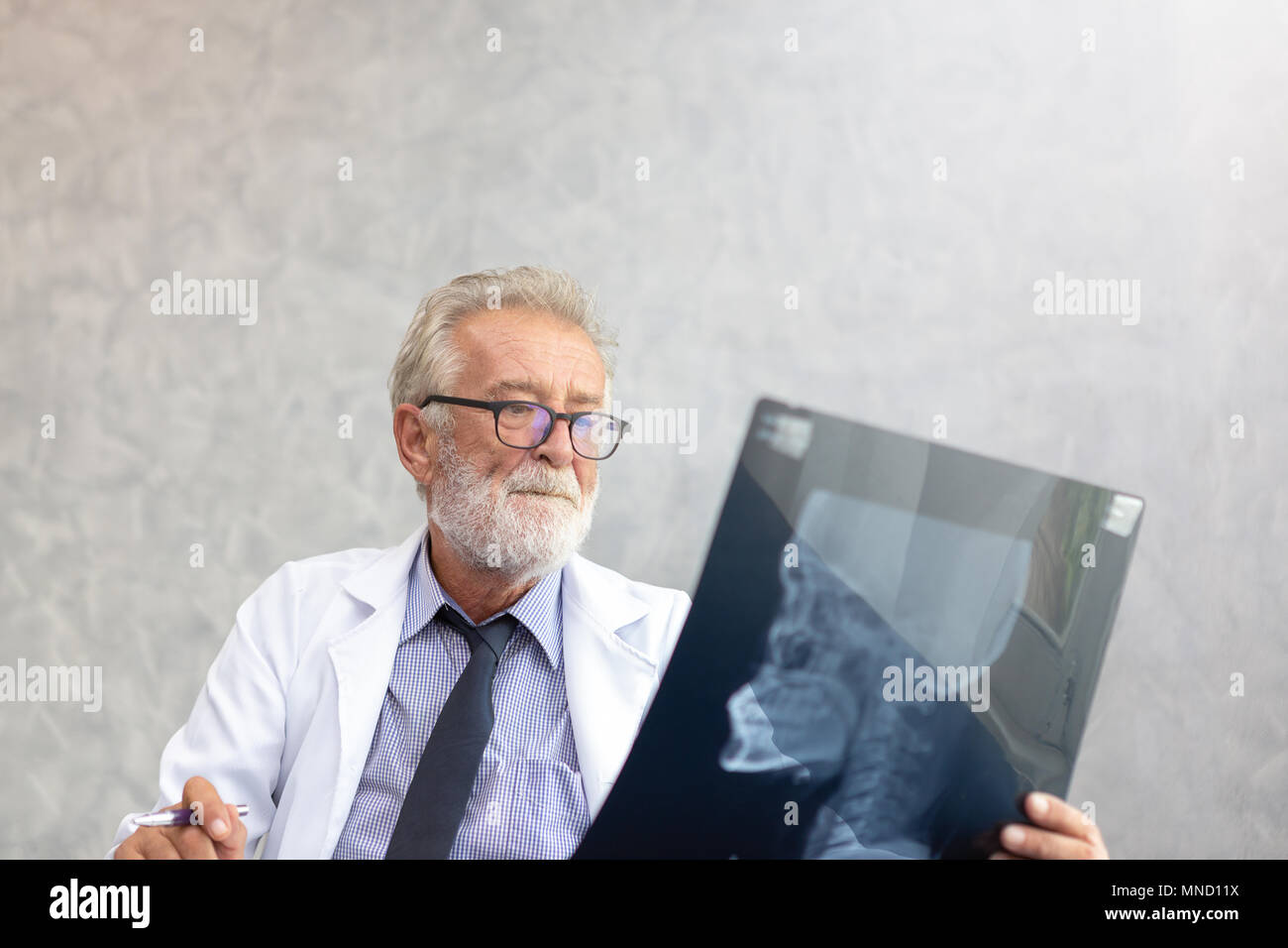 Senior medical doctor or chief doctor or Surgeon are checking skull of ...