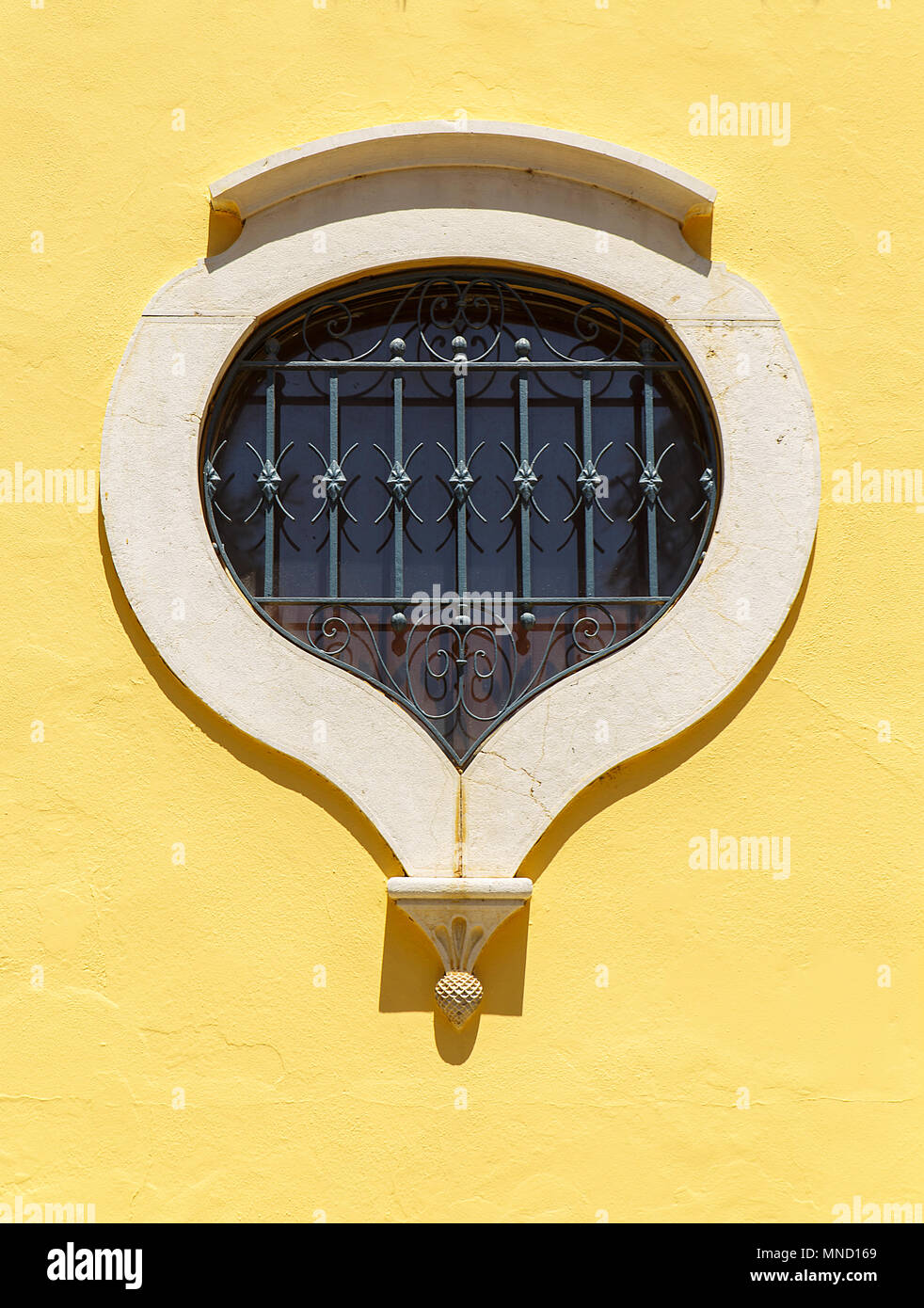 window in the shape of a tear on a yellow wall, algarve Stock Photo - Alamy