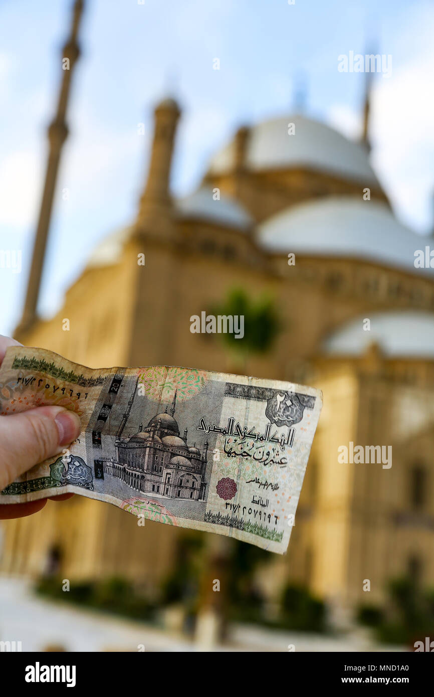 Someone holding up a 20 Egyptian Pound note showing the Great Mosque of ...