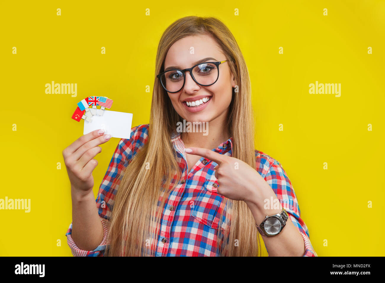 Young woman with card and flags of different speaking countries. Studio ... Young woman with card and flags of different speaking countries. Studio ...