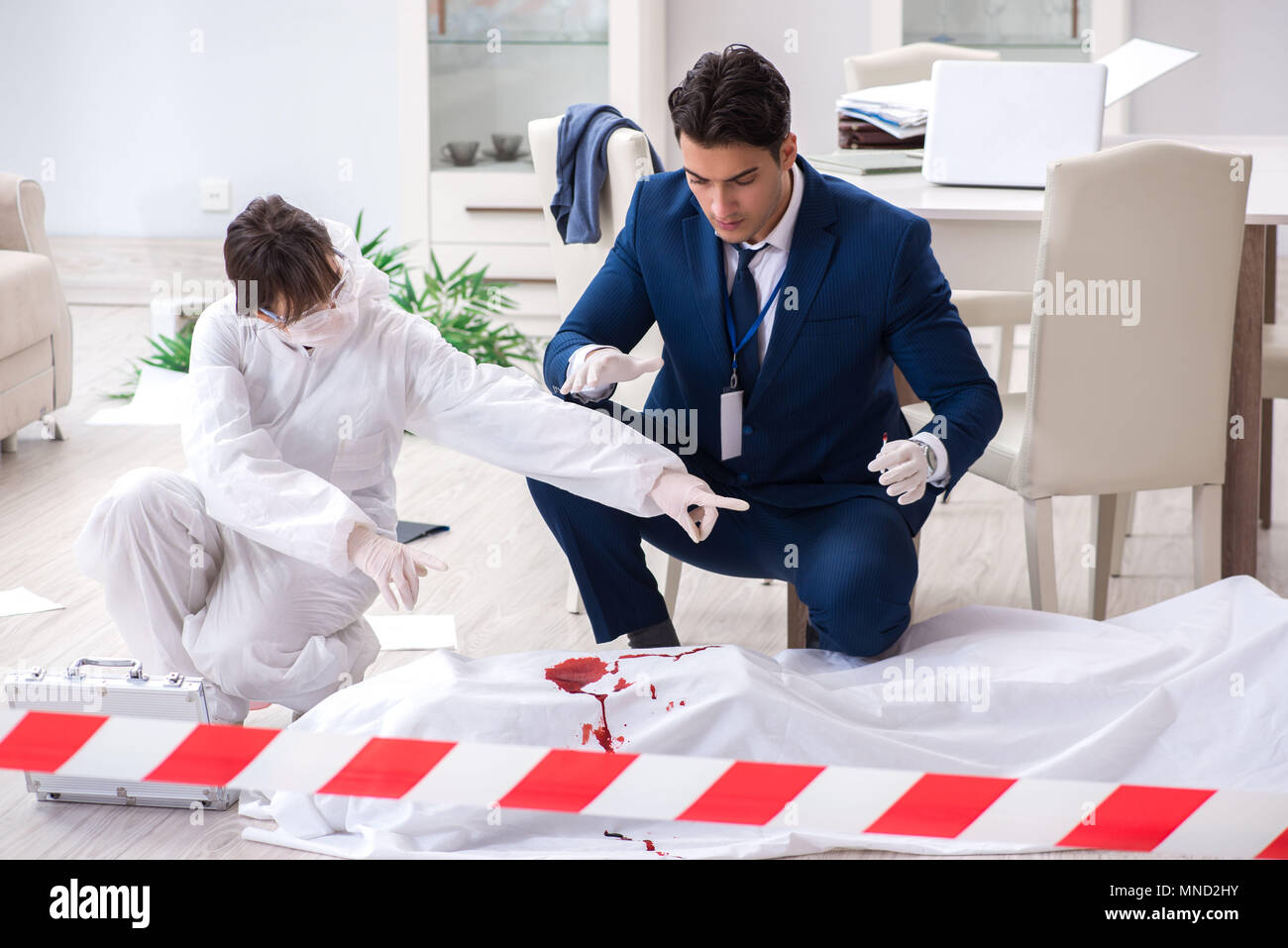 Forensics investigator at the scene of office crime Stock Photo - Alamy
