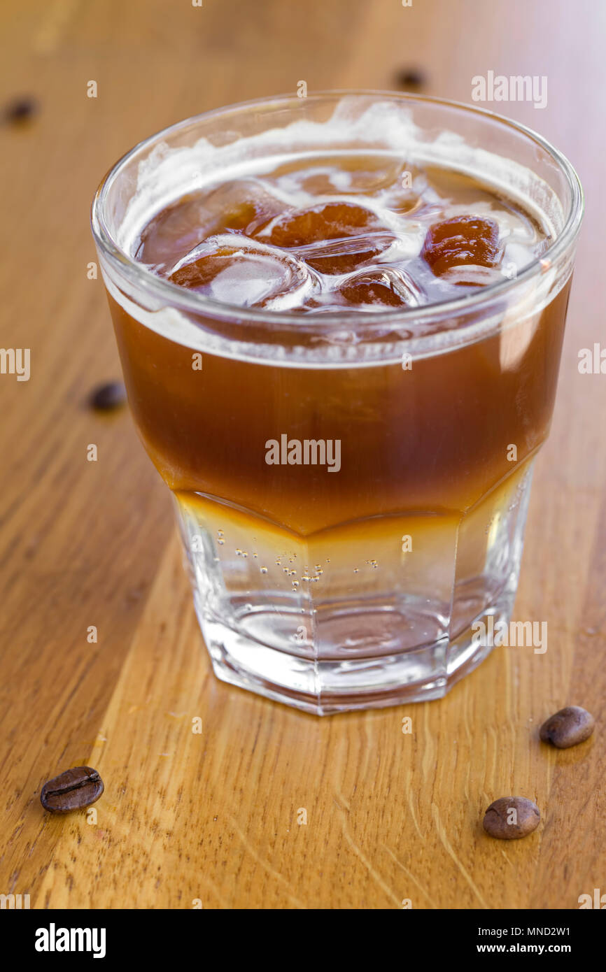 Cold coffee with ice cubes and coffee beans on the bar Stock Photo - Alamy