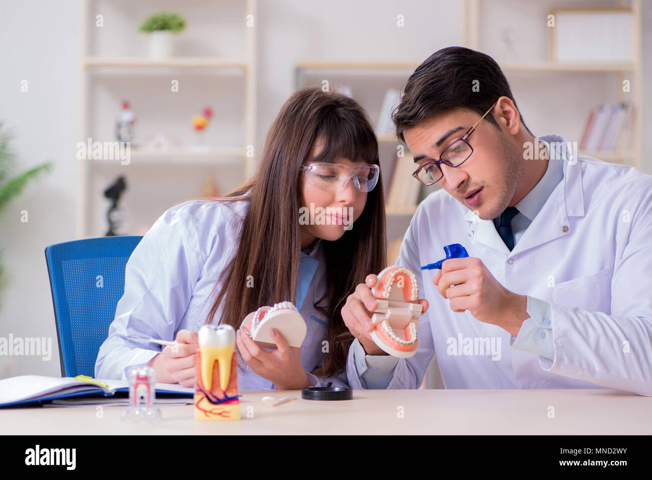 Dentist explaining brackets ligature setting Stock Photo - Alamy