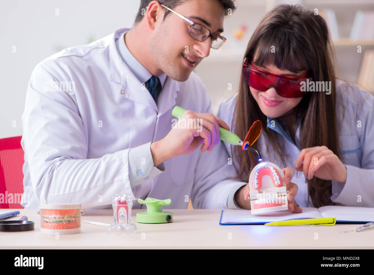 Doctor explaining to assistant how to use ultraviolet gun Stock Photo ...