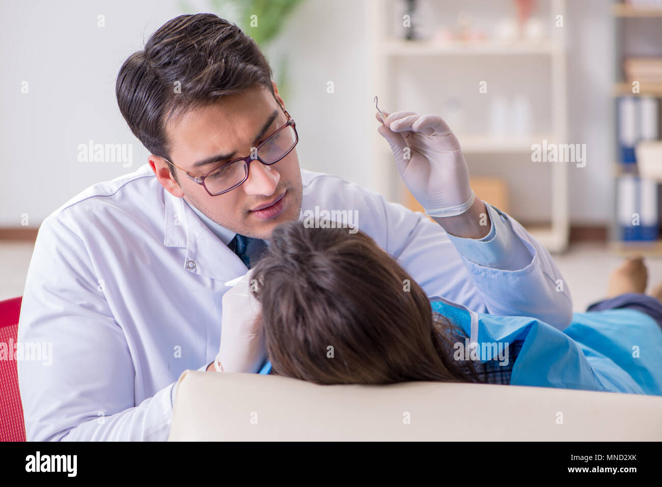 Patient visiting dentist for regular check-up and filling Stock Photo ...