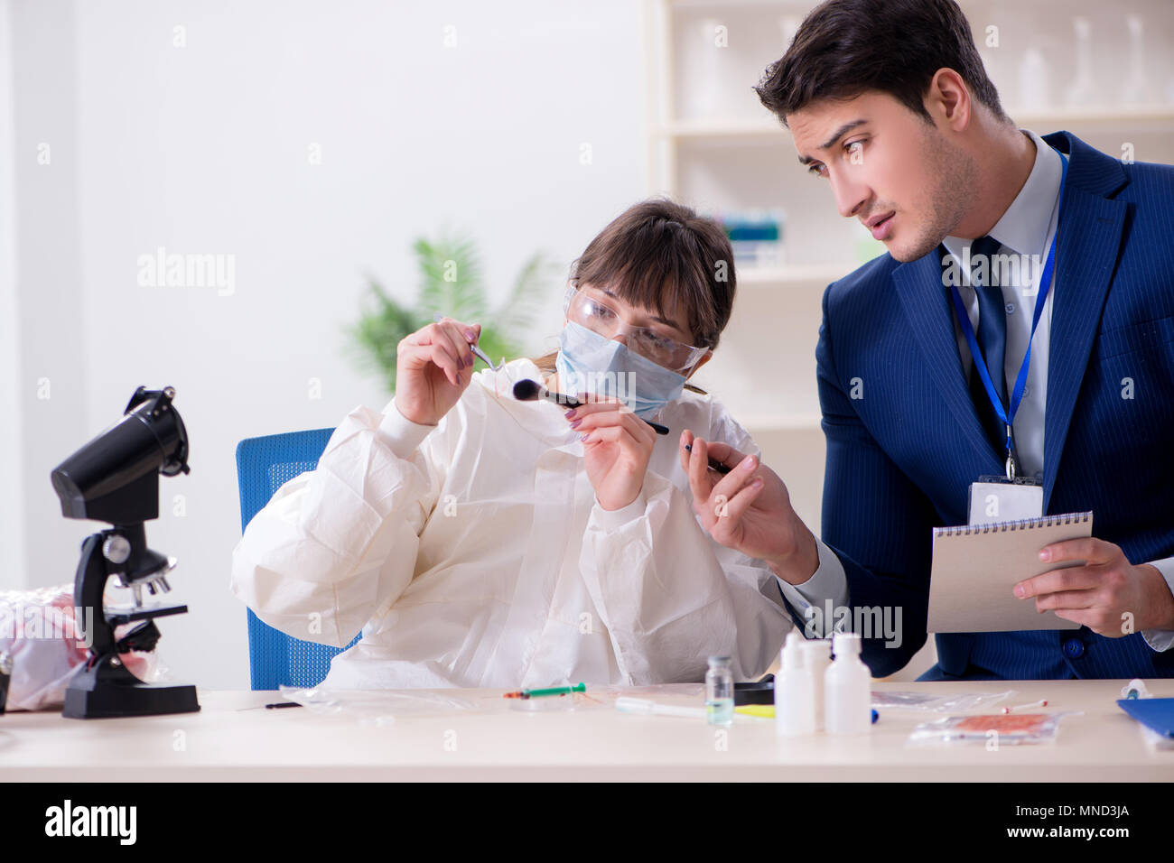 Expert criminologist working in the lab for evidence Stock Photo - Alamy