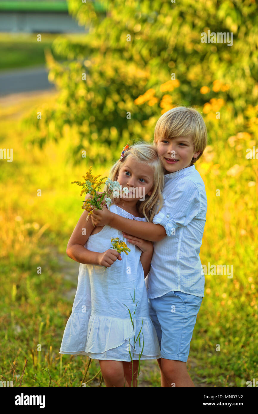Young kids are hugging each other Stock Photo - Alamy