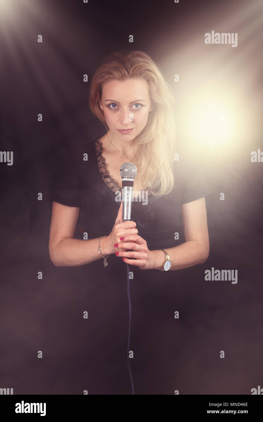 beautiful singer sings the song in the spotlight Stock Photo - Alamy