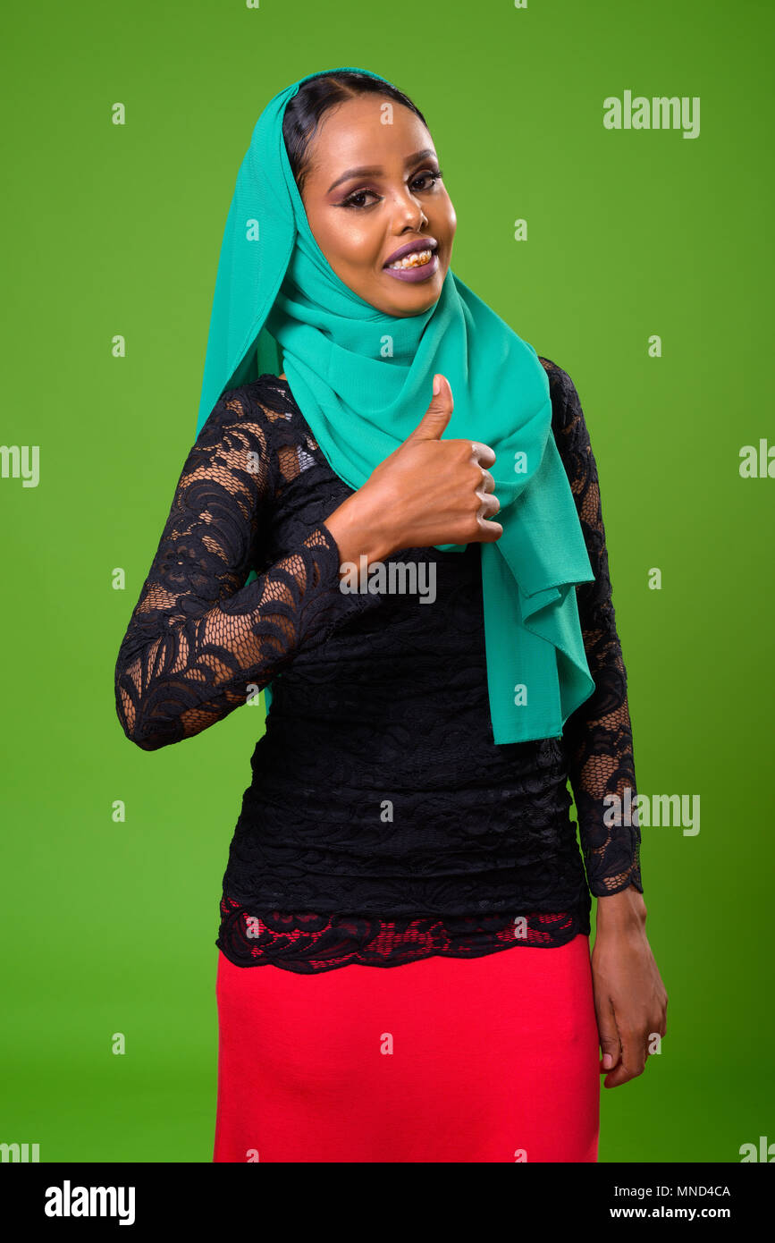 Young African Muslim woman against chroma key with green background ...
