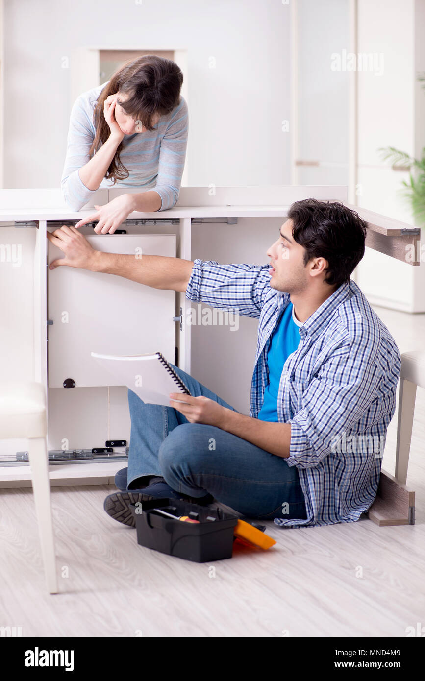 Husband repairing broken table at home Stock Photo - Alamy
