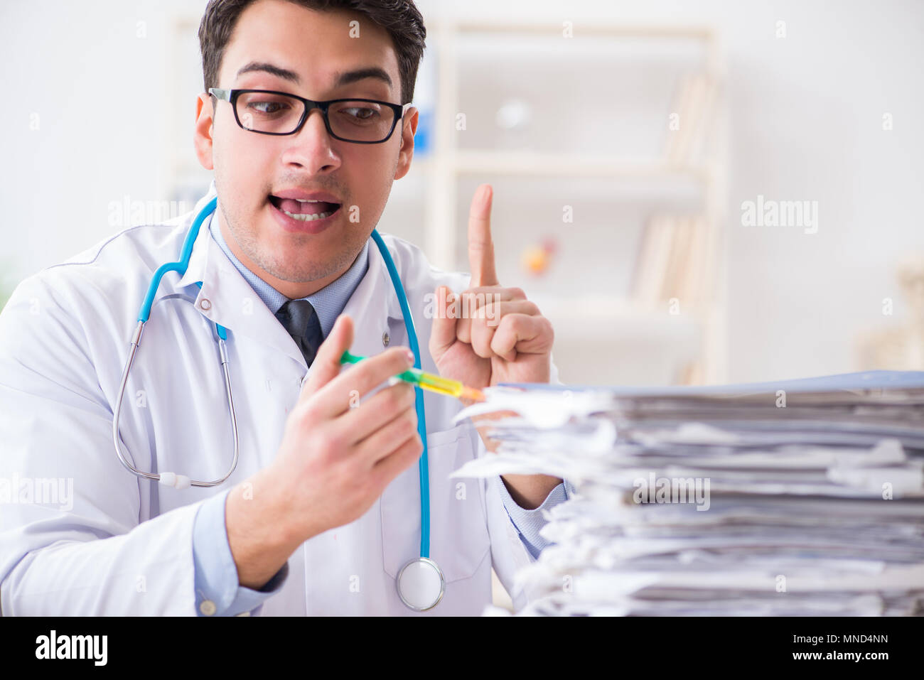 Busy doctor with too much work in hospital Stock Photo - Alamy