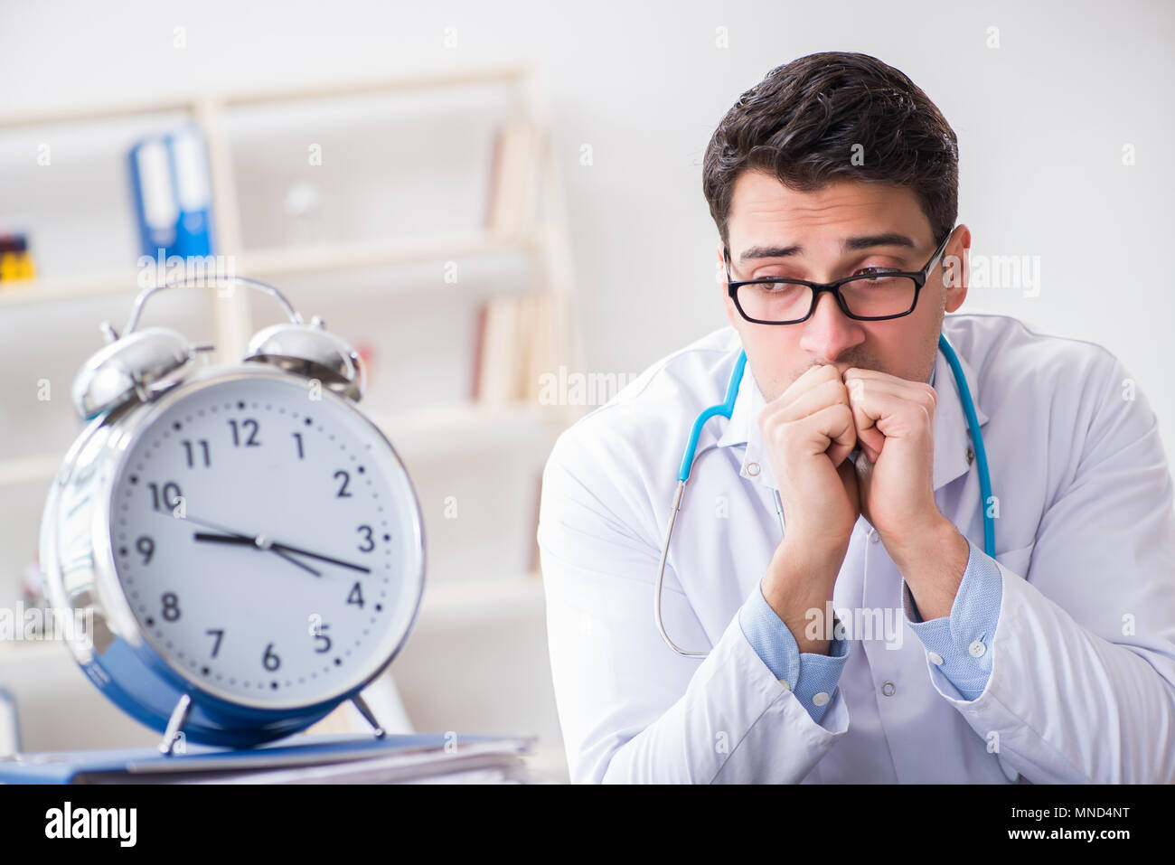 Doctor with alarm clock in urgent check-up concept Stock Photo - Alamy