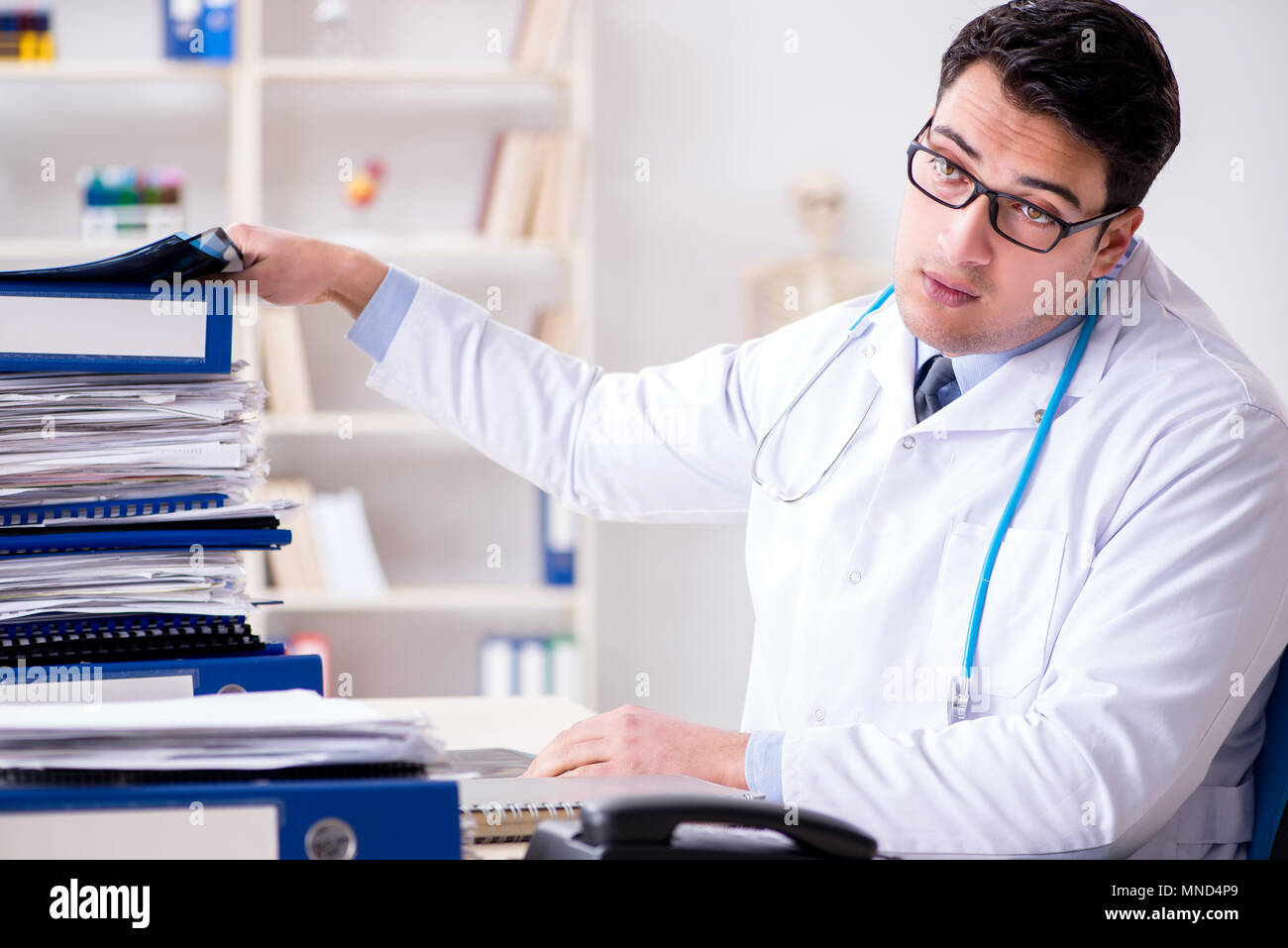Busy doctor with too much work in hospital Stock Photo - Alamy