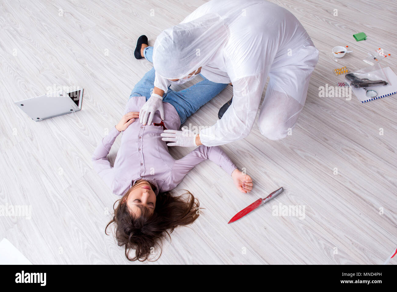 Forensic investigator at the crime scene investigating woman murder ...
