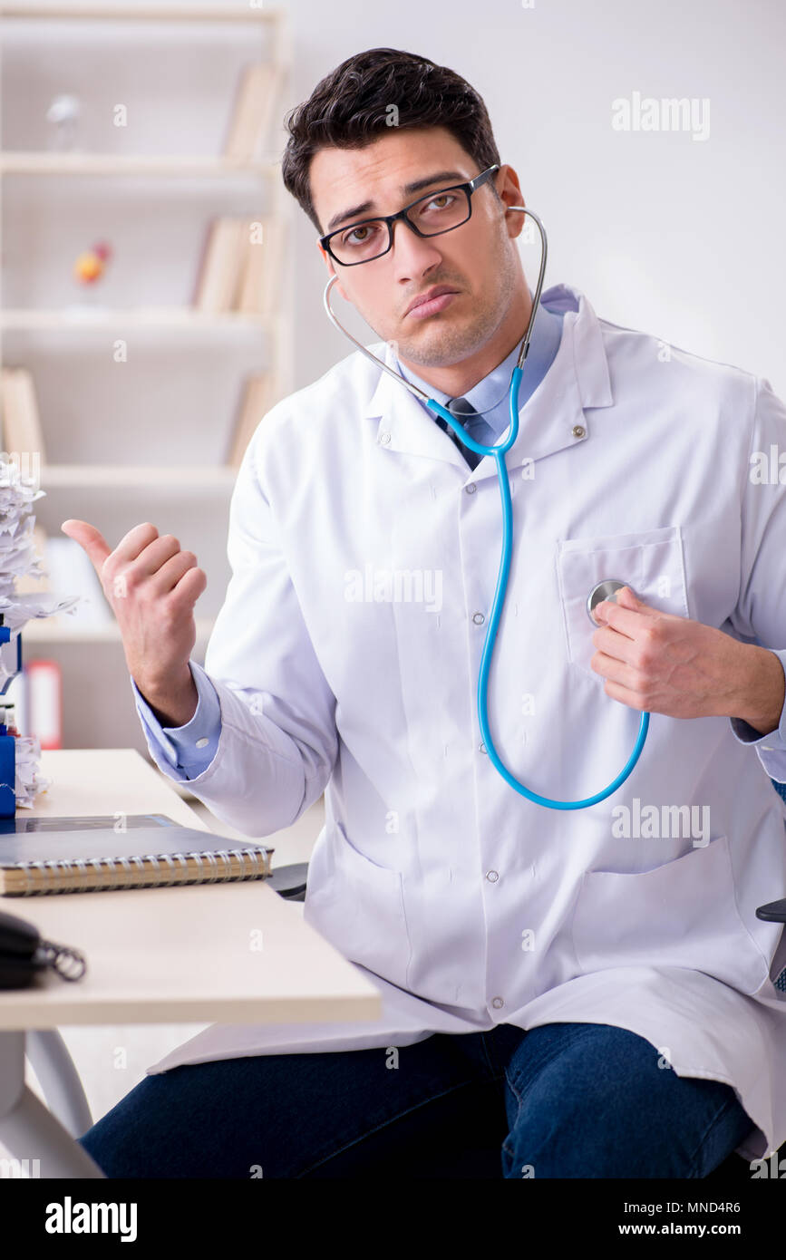 Busy doctor with too much work in hospital Stock Photo - Alamy