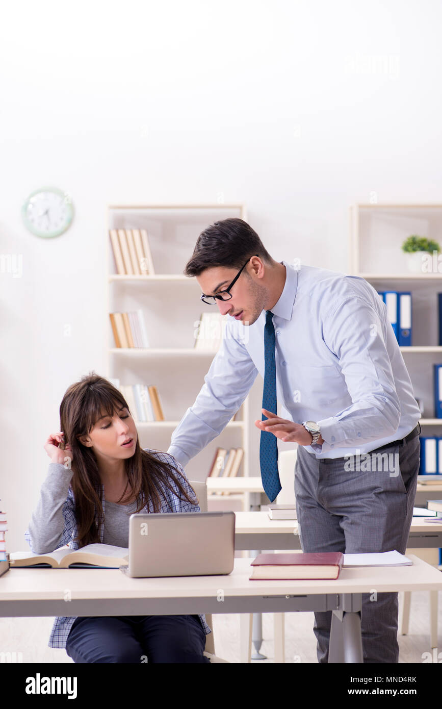 Male lecturer giving lecture to female student Stock Photo - Alamy