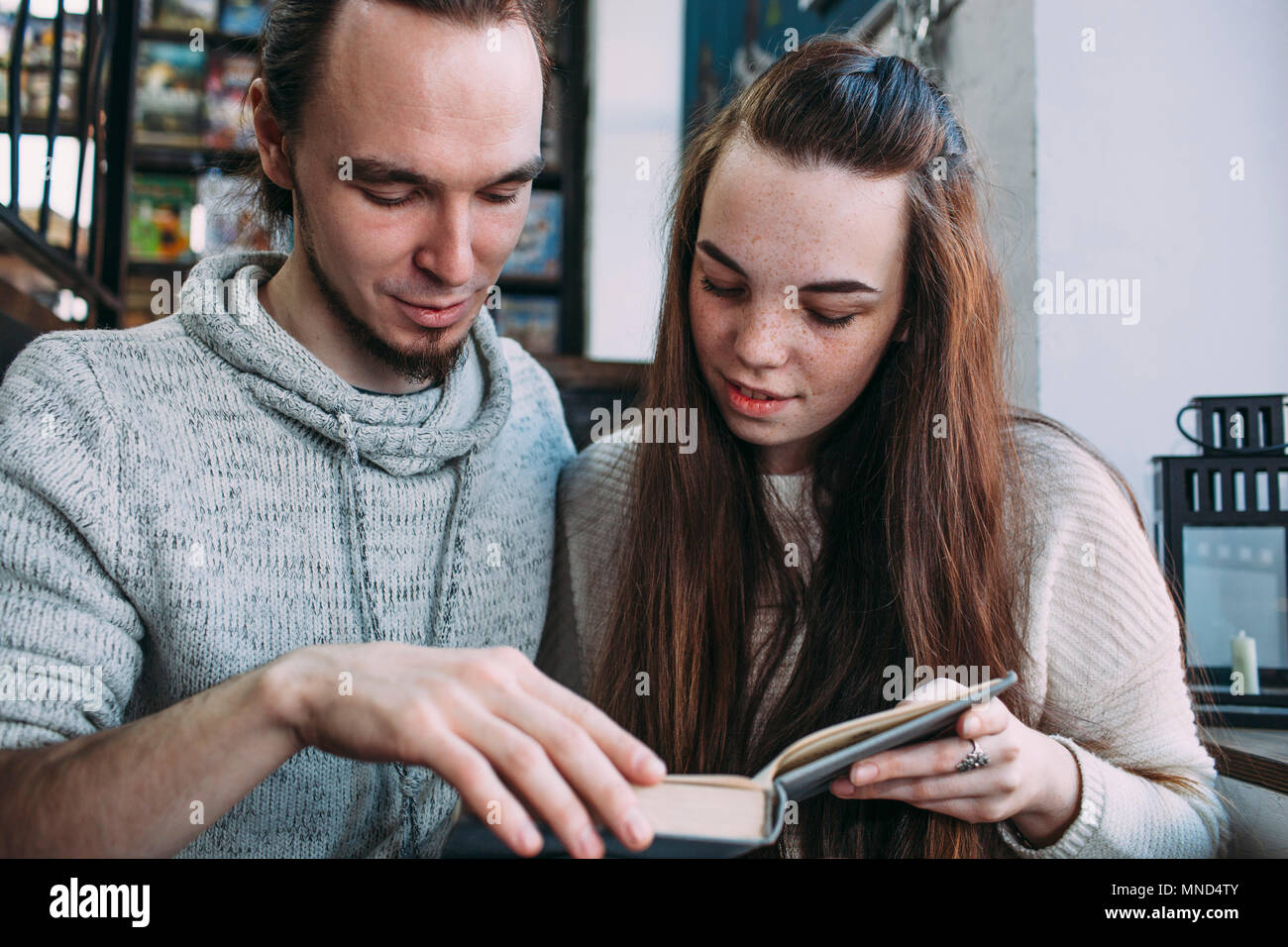 Young couple reading book hi-res stock photography and images - Alamy