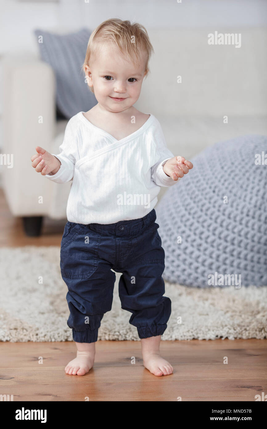 Full length of cute baby girl standing at home Stock Photo - Alamy