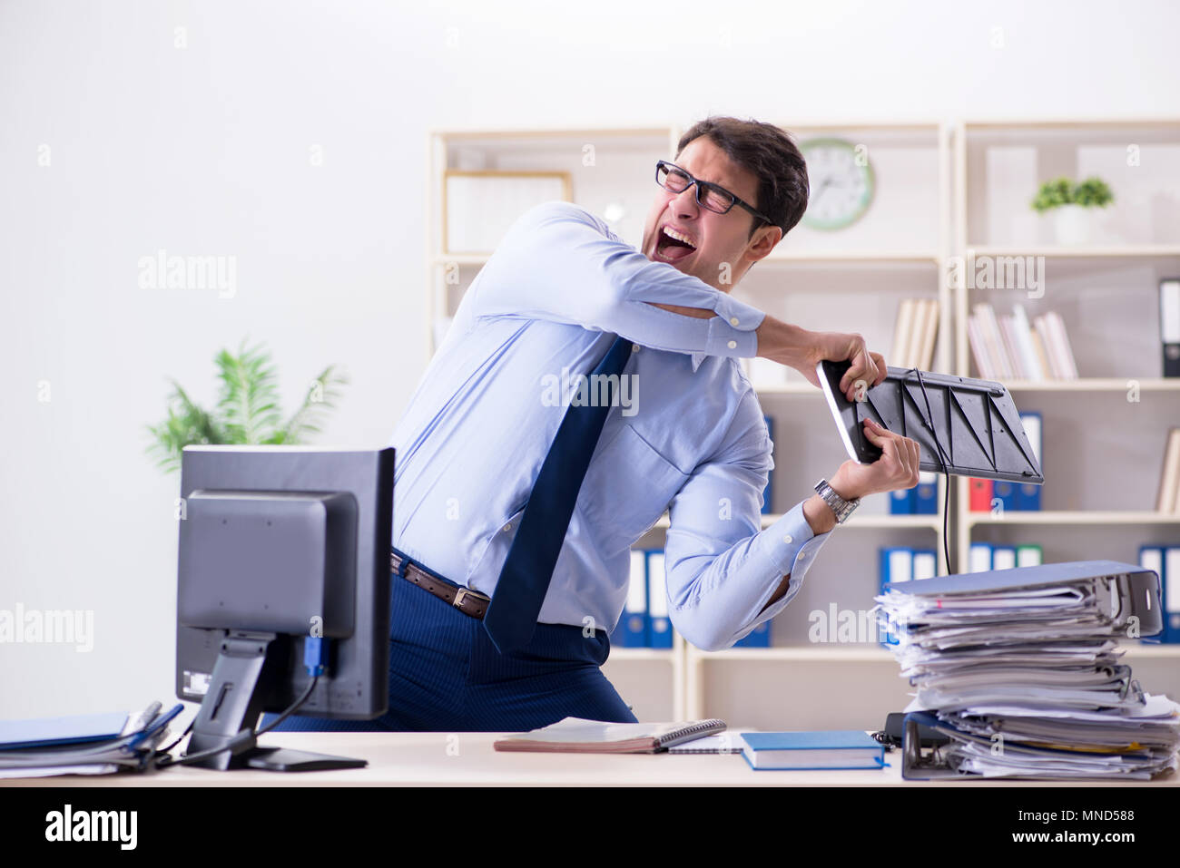 Angry businessman frustrated with too much work Stock Photo - Alamy