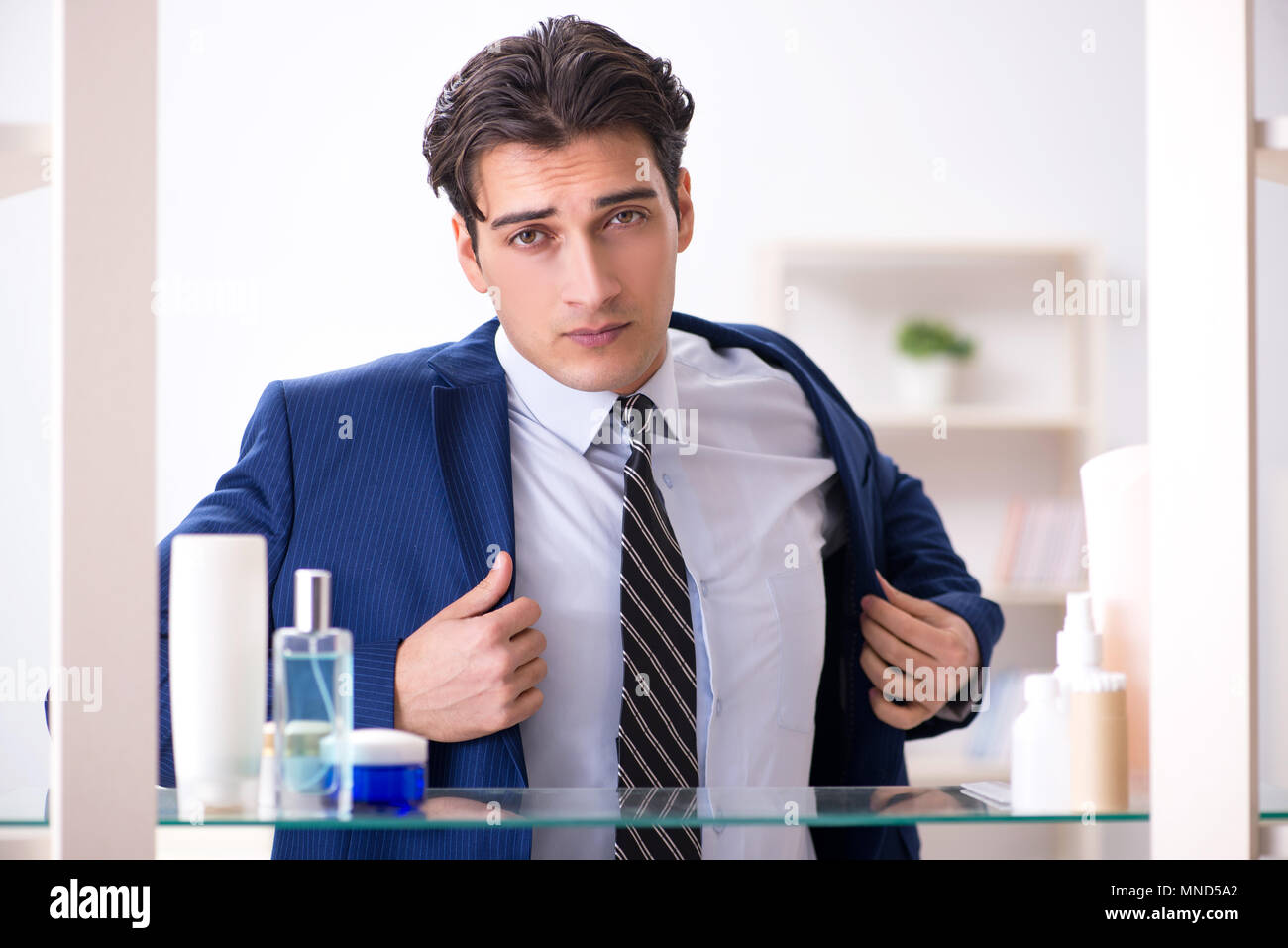 Man is getting dressed up for work in bathroom Stock Photo - Alamy