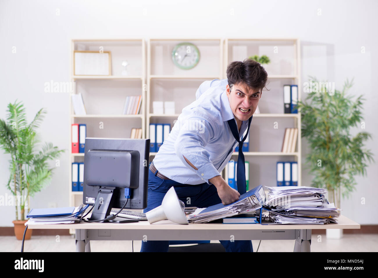 Angry businessman frustrated with too much work Stock Photo - Alamy
