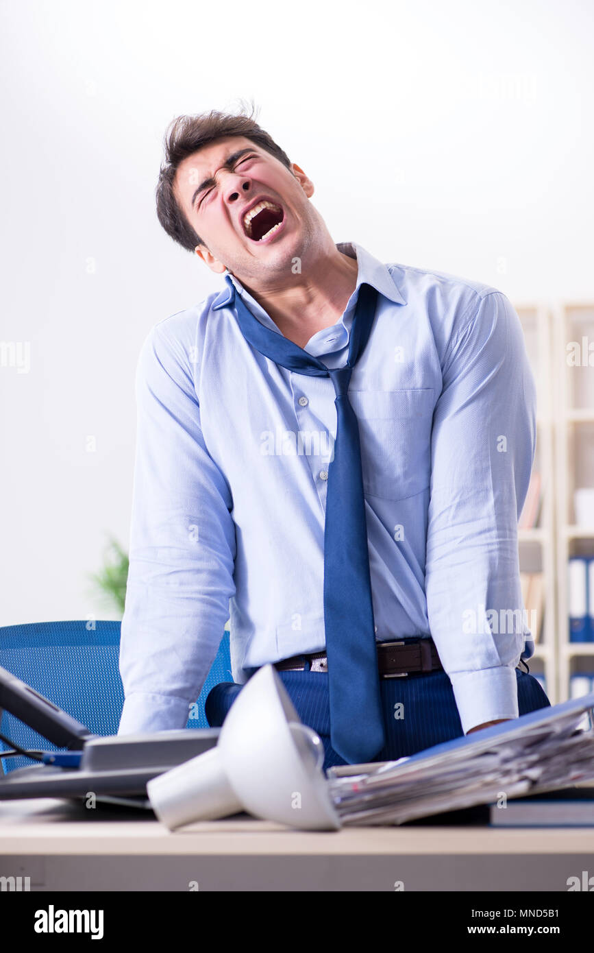 Angry businessman frustrated with too much work Stock Photo - Alamy