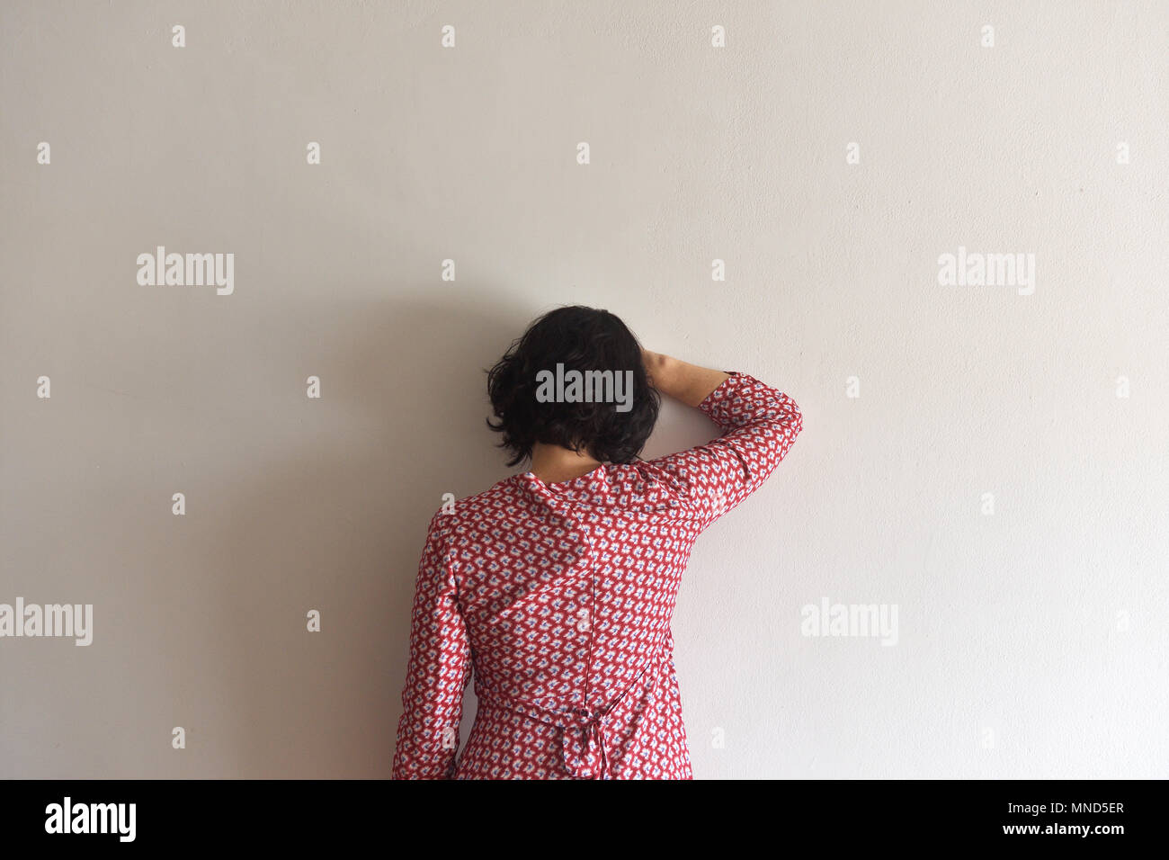 Opposite woman on her back on a wall Stock Photo - Alamy