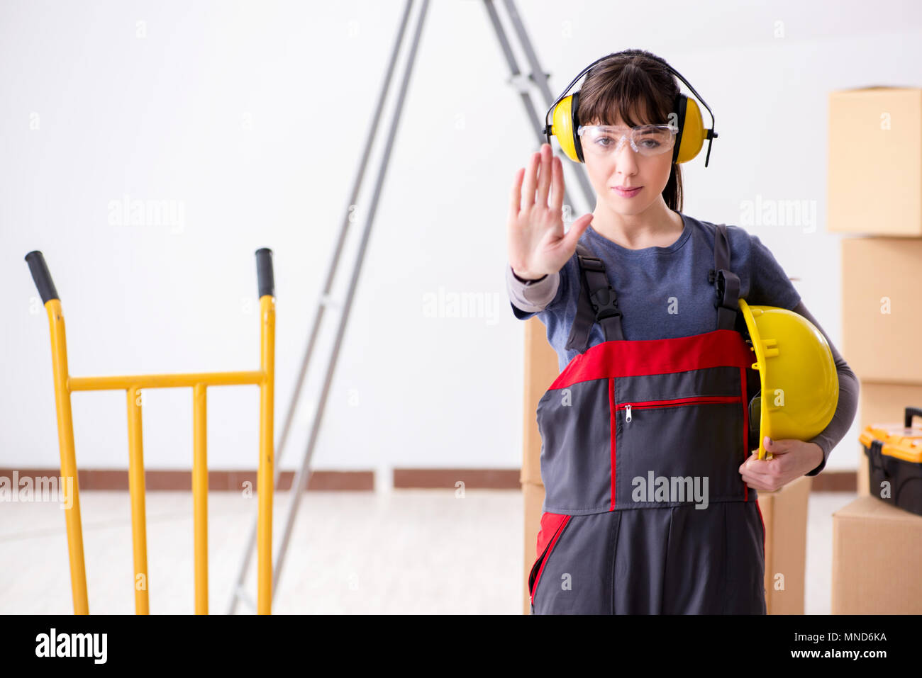 Woman contractor worker with noise cancelling headphones Stock Photo ...