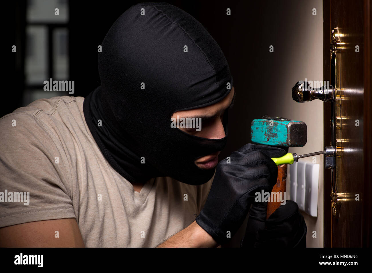 Burglar wearing balaclava mask at crime scene Stock Photo - Alamy